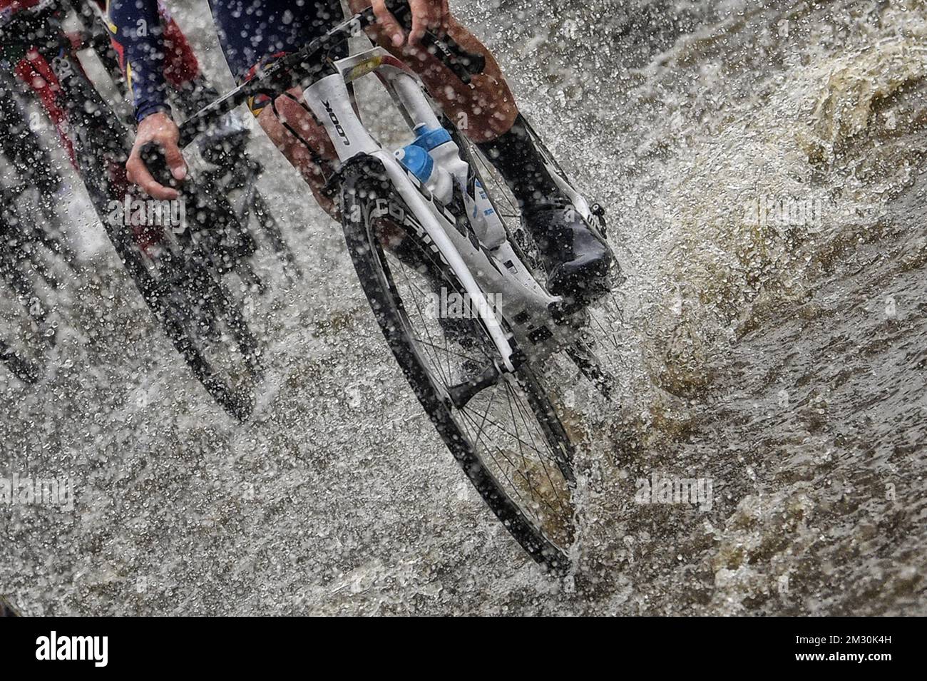 Illustration picture shows a cyclist riding through water during the ...