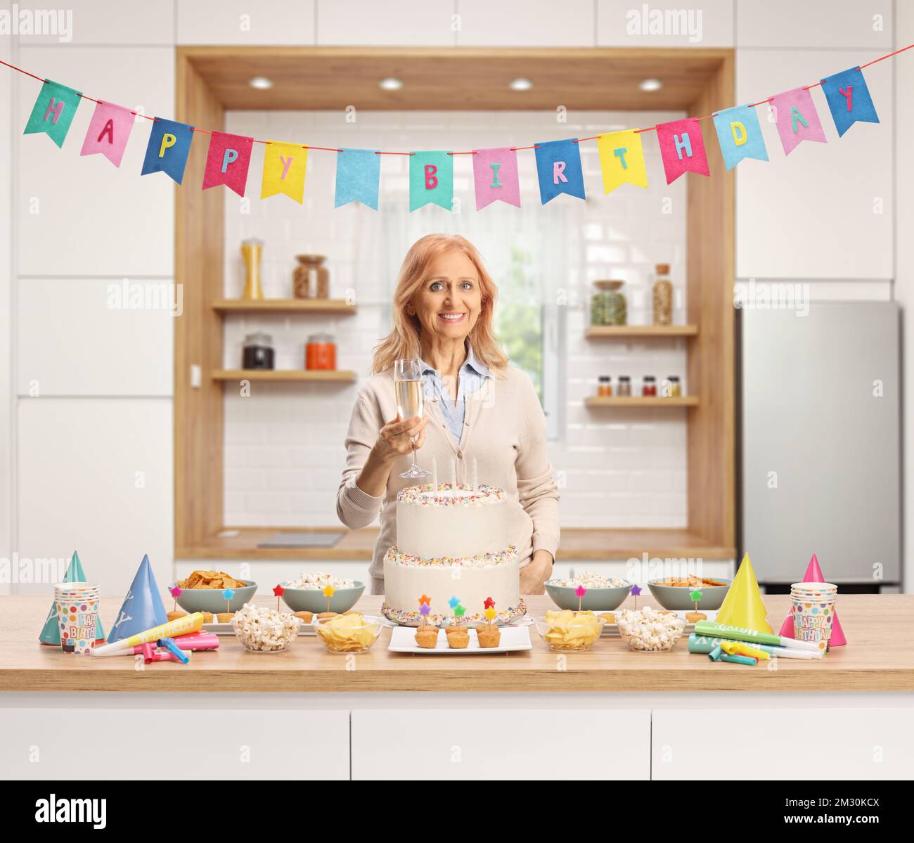 Casual woman celebrating birthday with a glass of champagne inside a ...