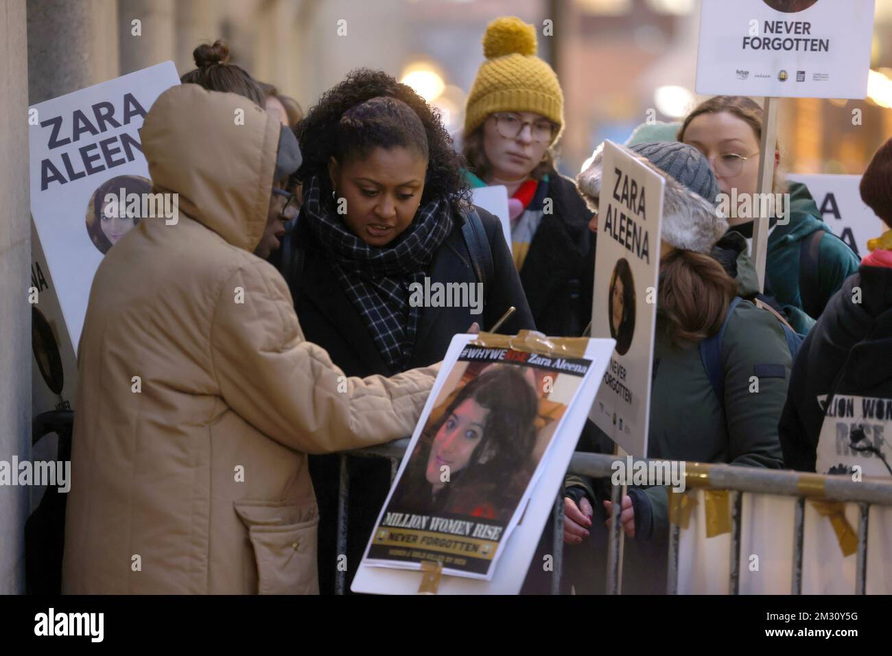 Protesters from Million Women Rise listen on a mobile phone outside the ...