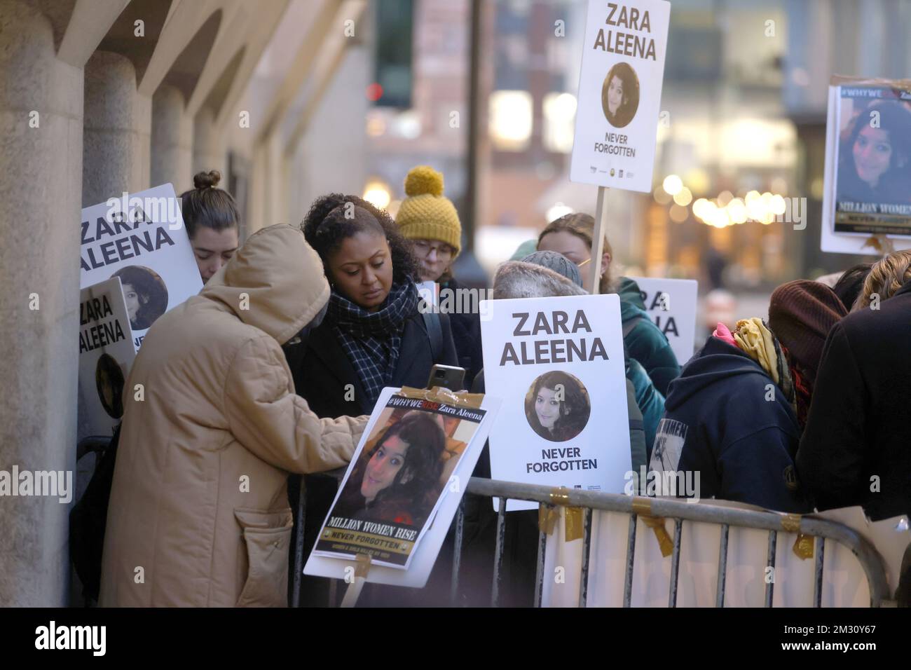 Protesters from Million Women Rise listen on a mobile phone outside the ...
