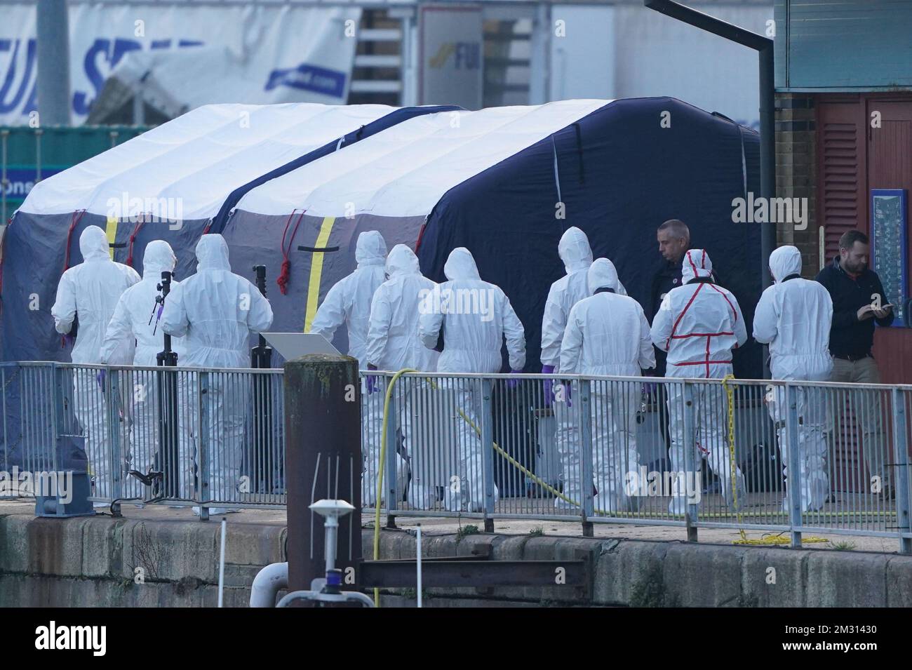 Police Forensic officers head to the forensic tents erected at the RNLI ...