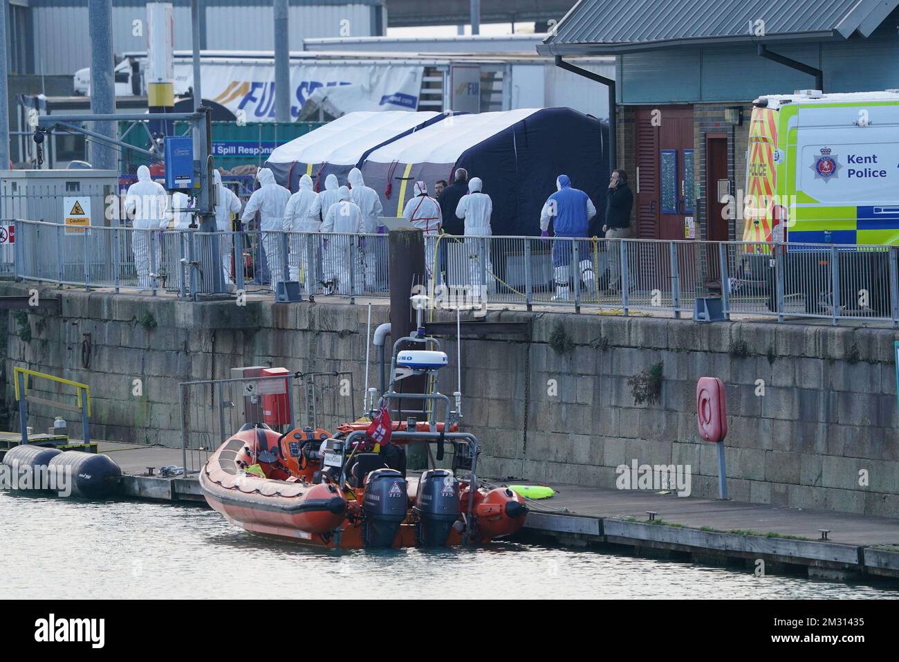 Police Forensic officers head to the forensic tents erected at the RNLI ...
