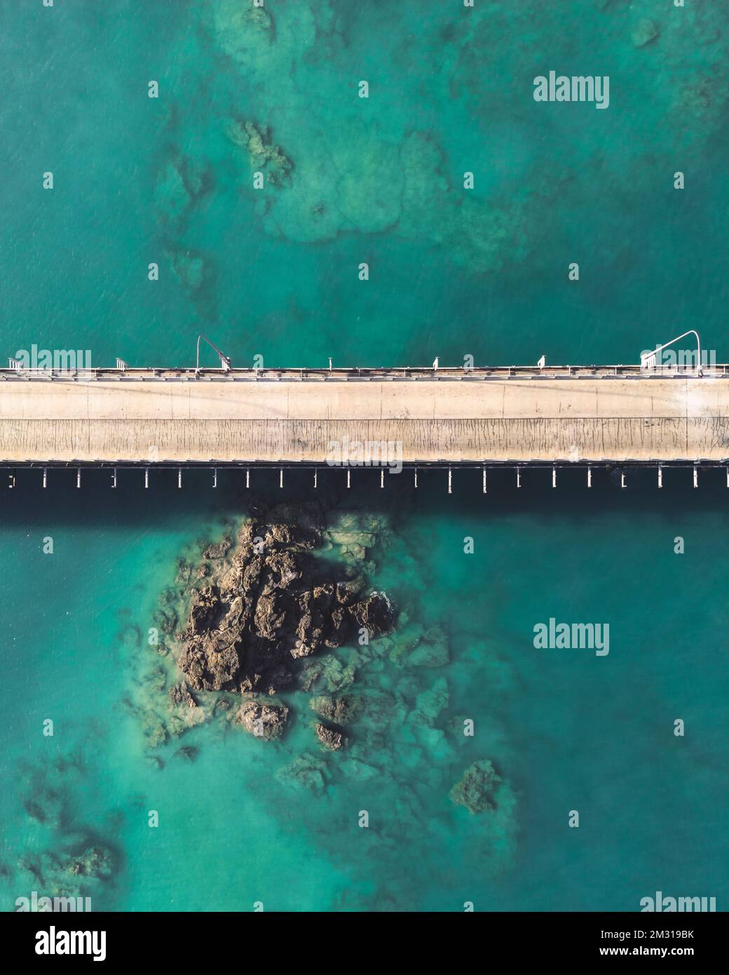 An aerial view of the road over the sea at daytime Stock Photo - Alamy