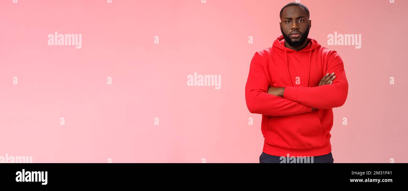 Serious-looking strong black guy security worker cross hands chest ...