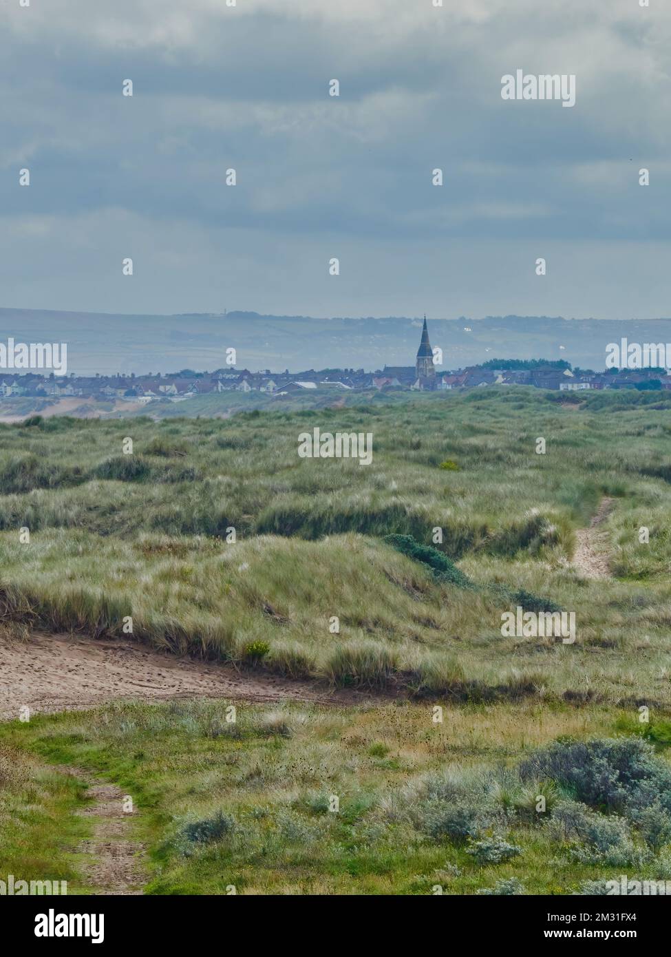 The steeple of Coatham Church and its surrounding houses seen against ...