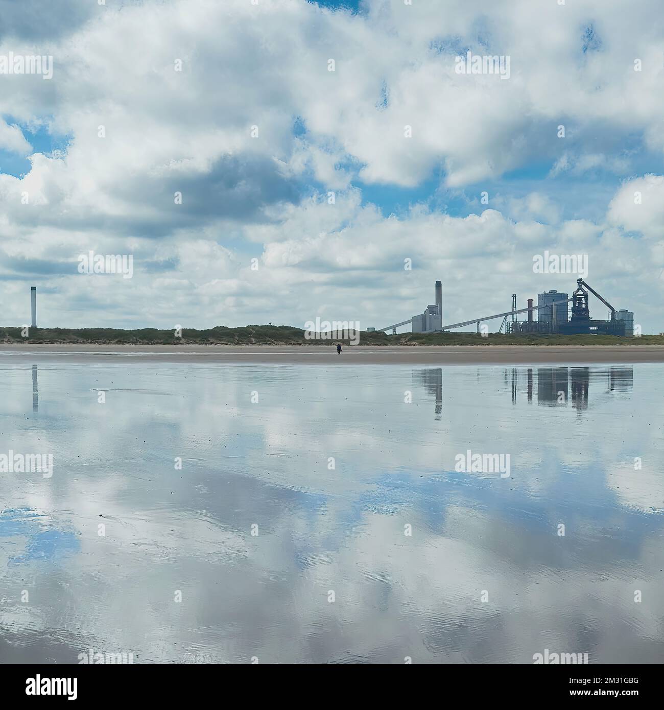 A tiny, distant figure lends scale to a massive industrial landscape ...