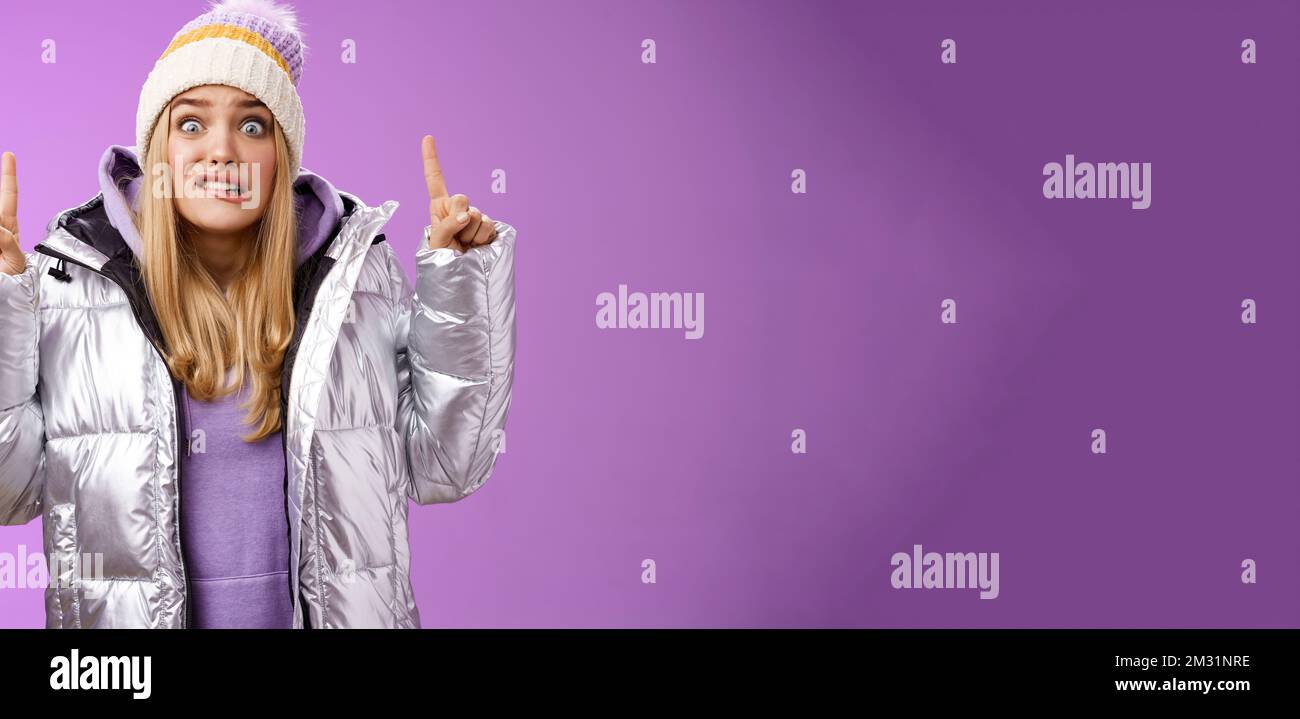 Scared unsure worried awkward young cute blond girl biting lip stooping ...