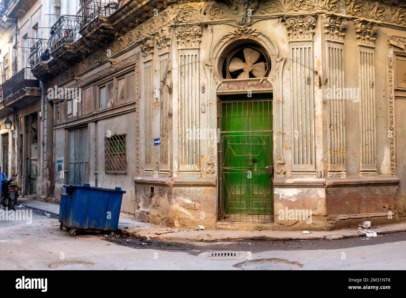 The door of a weathered building is protected with an anti-theft metal ...