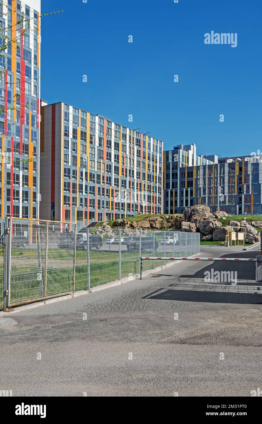 New brightly painted urban high-rise buildings on a sunny summer day ...
