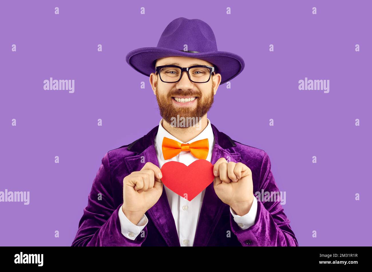 Photo of cheerful confident man with big red paper heart and smiling ...