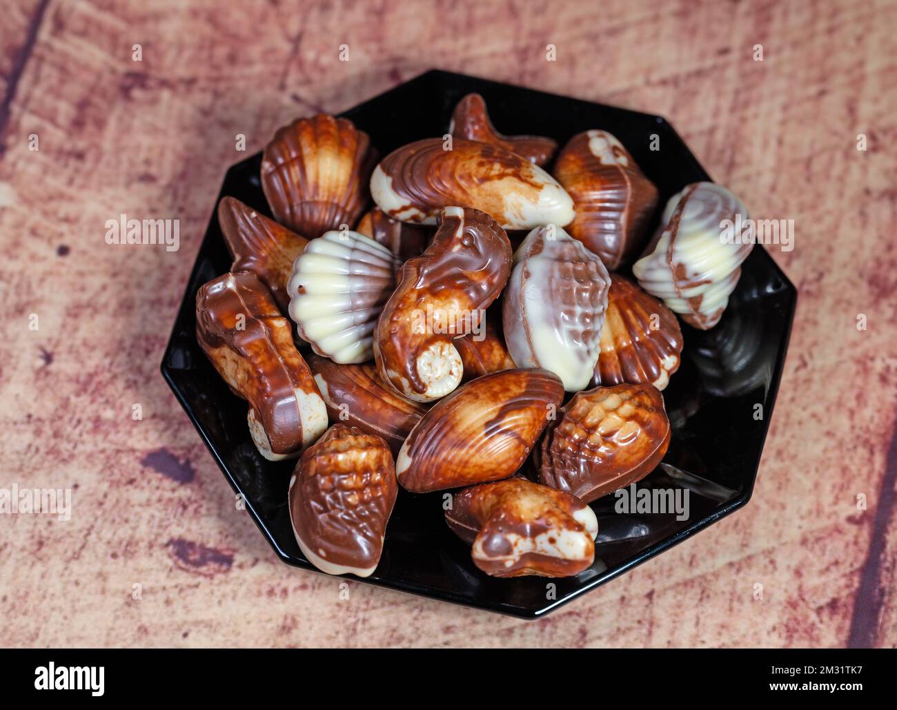 Chocolate seafood on black plate Stock Photo - Alamy