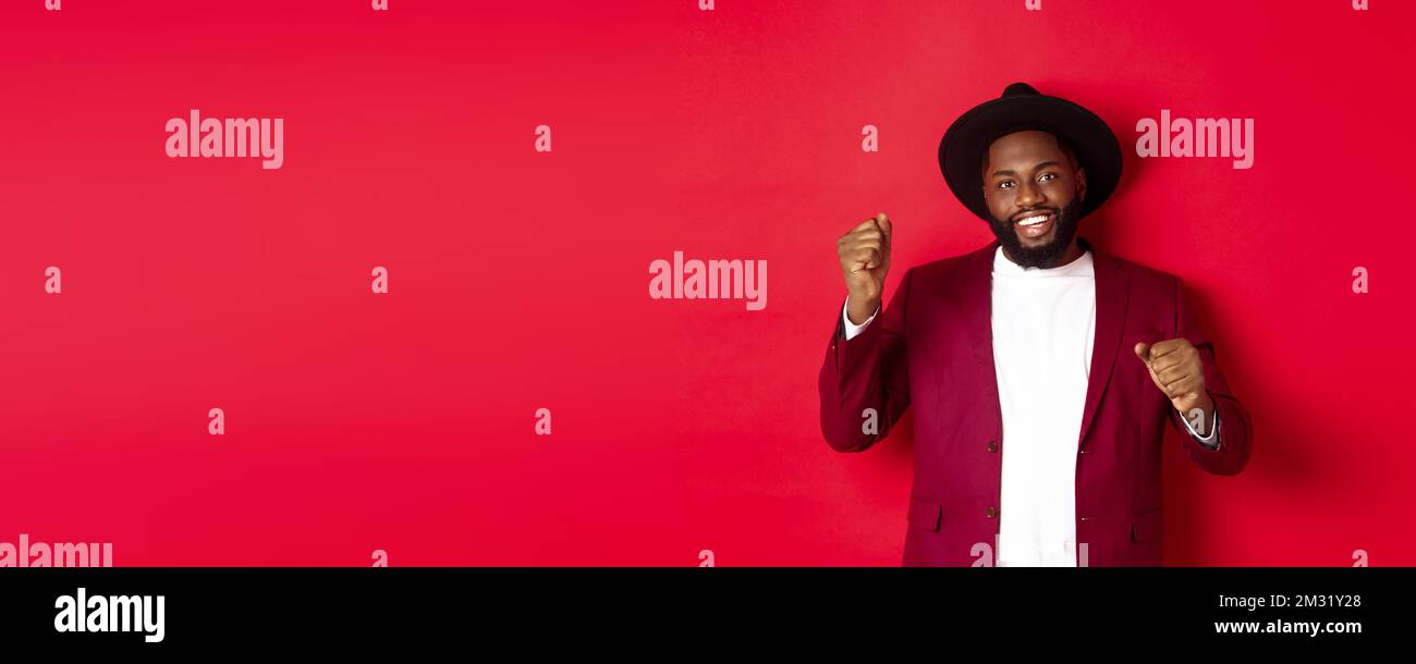 Fashion and party concept. Handsome Black man celebrating in jacket and ...