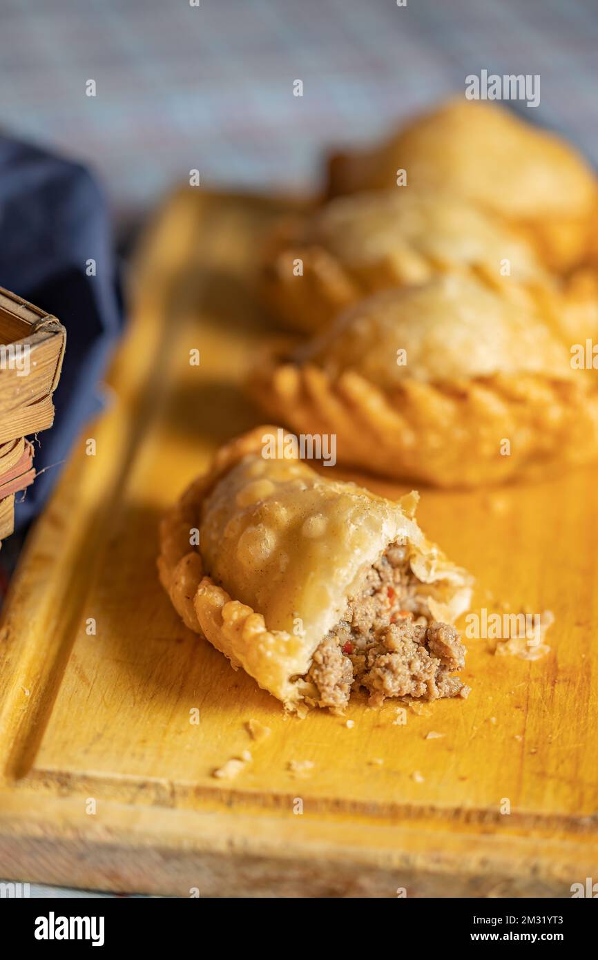 Close up of fried Argentine empanada cut in the middle Stock Photo - Alamy