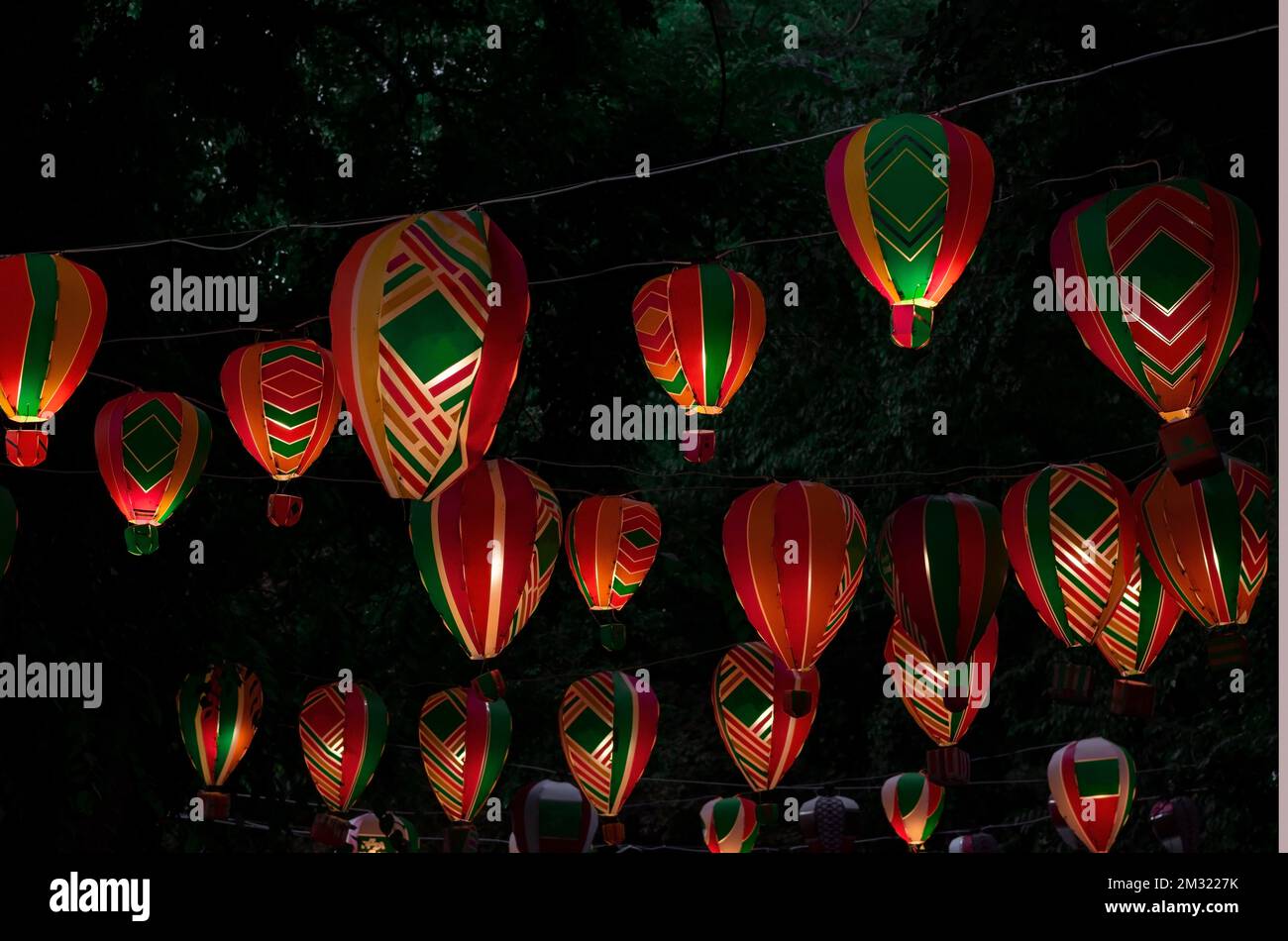 Festive and colorful illuminated lanterns or lampions over a mall in ...
