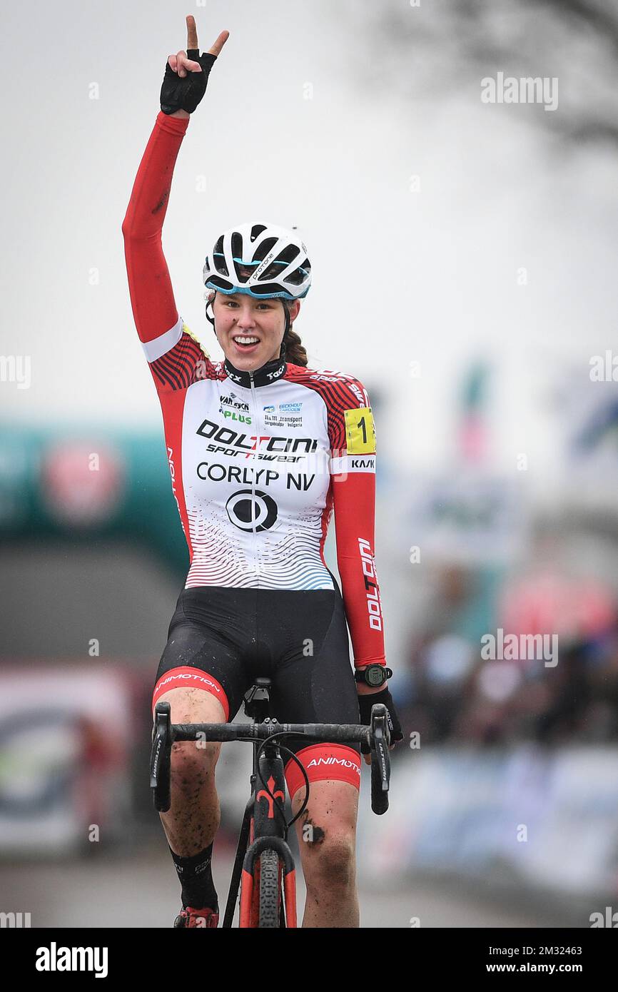 Belgian Julie De Wilde celebrates as she crosses the finish line to win ...