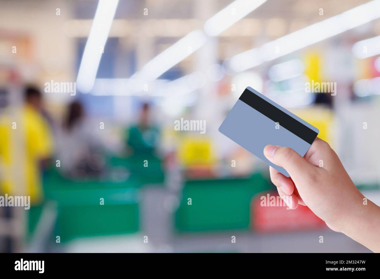 paying using credit card at supermarket checkout cashier counter in ...