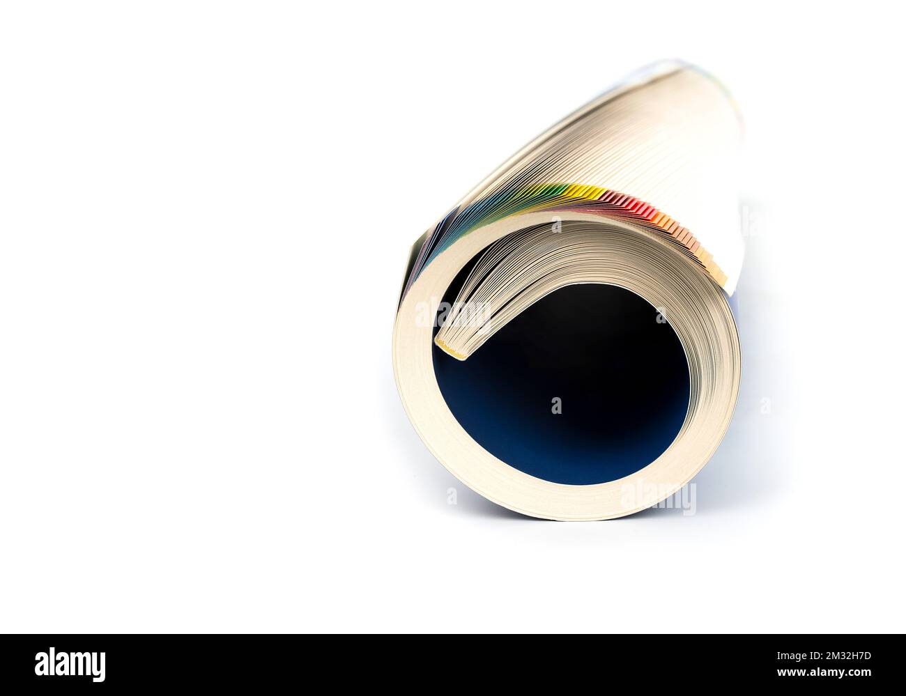 Rolled up magazines on a white background Stock Photo - Alamy