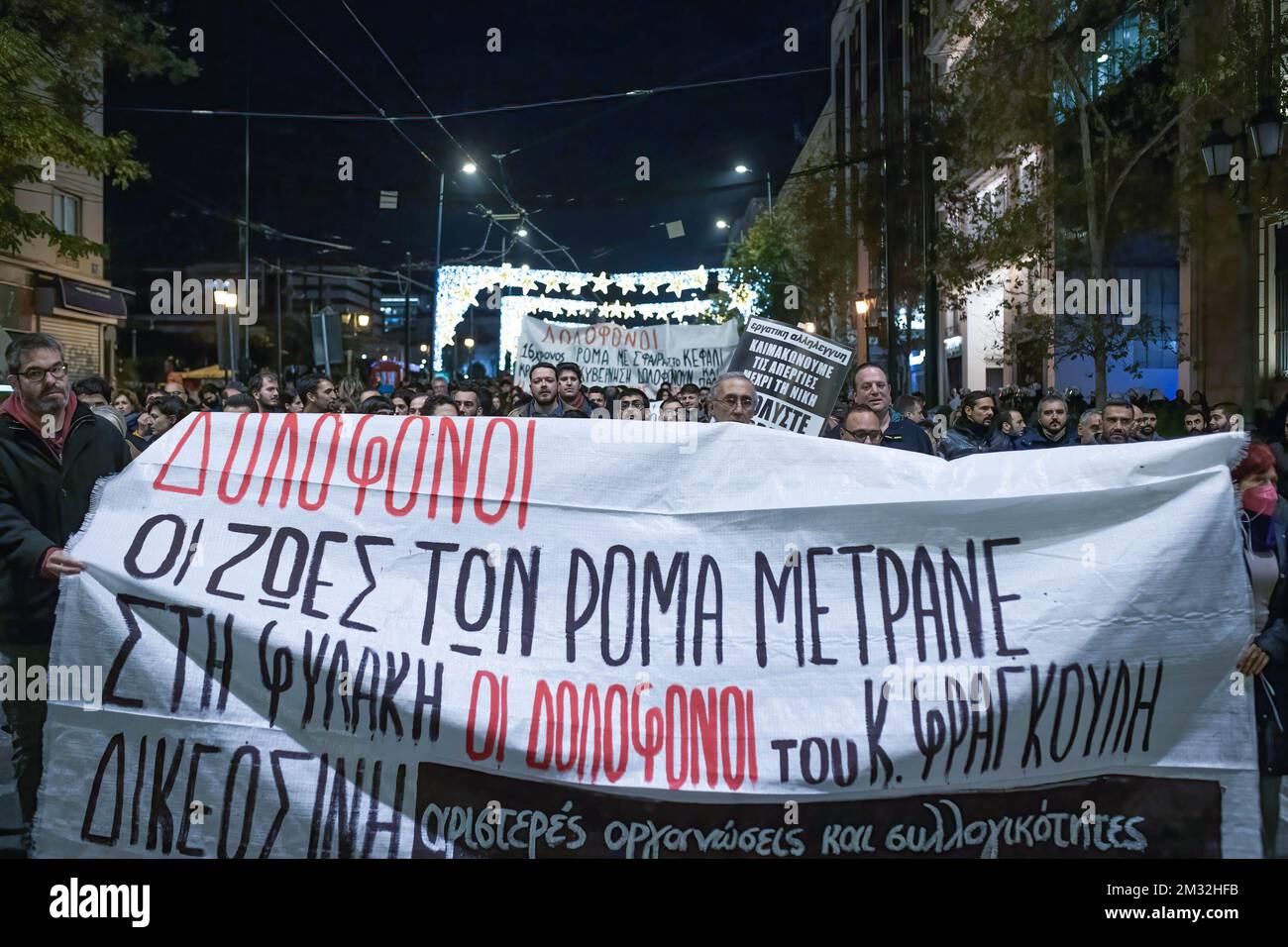 Protesters hold a banner saying "Murderers. Roma lives matter" during ...
