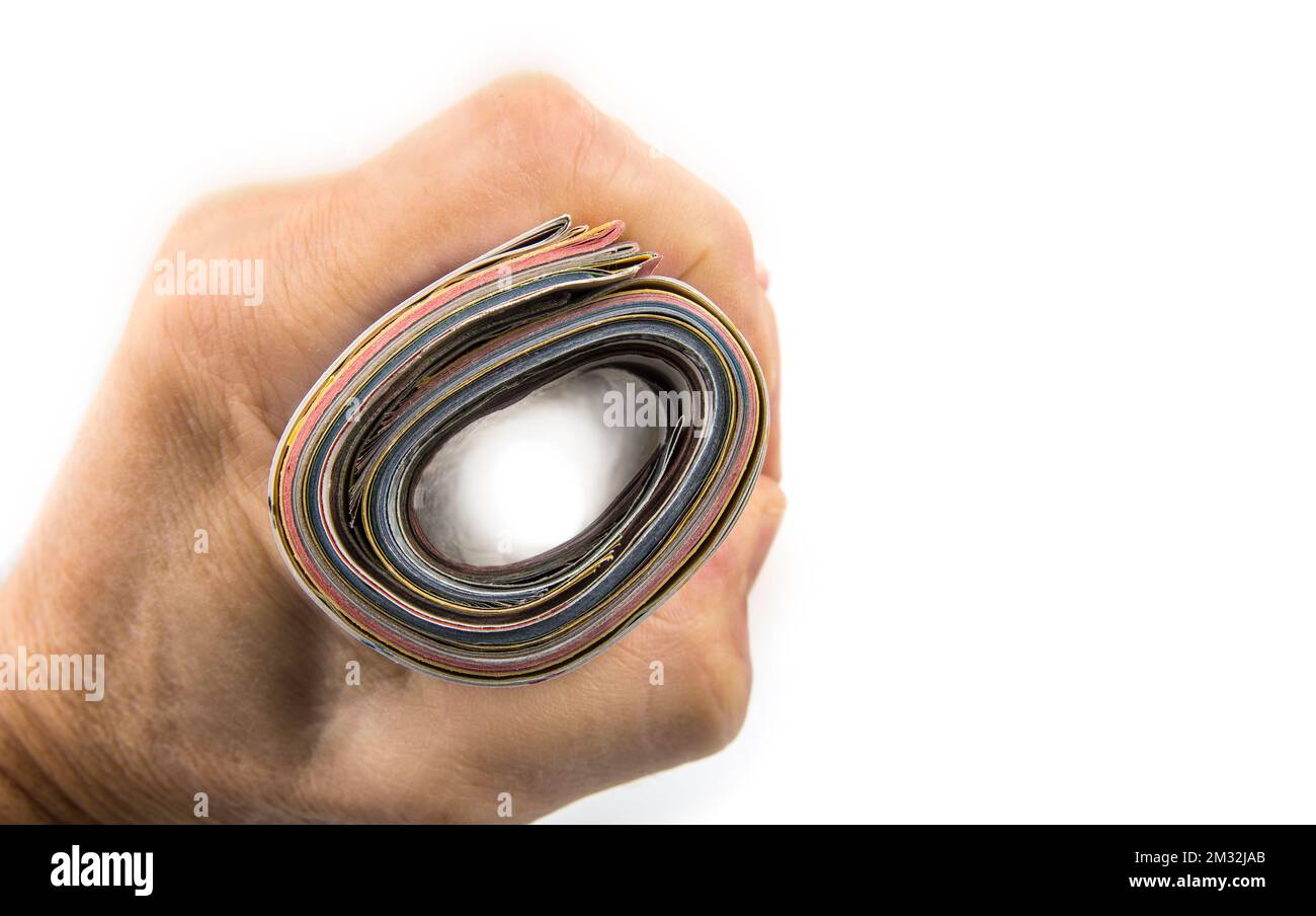 Rolled up magazines in the hand on a white background Stock Photo - Alamy