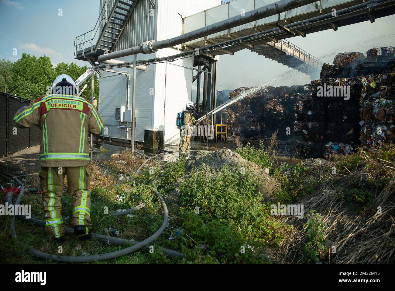 Firemen pictured in action on the scene of a fire at the VPK paper and ...