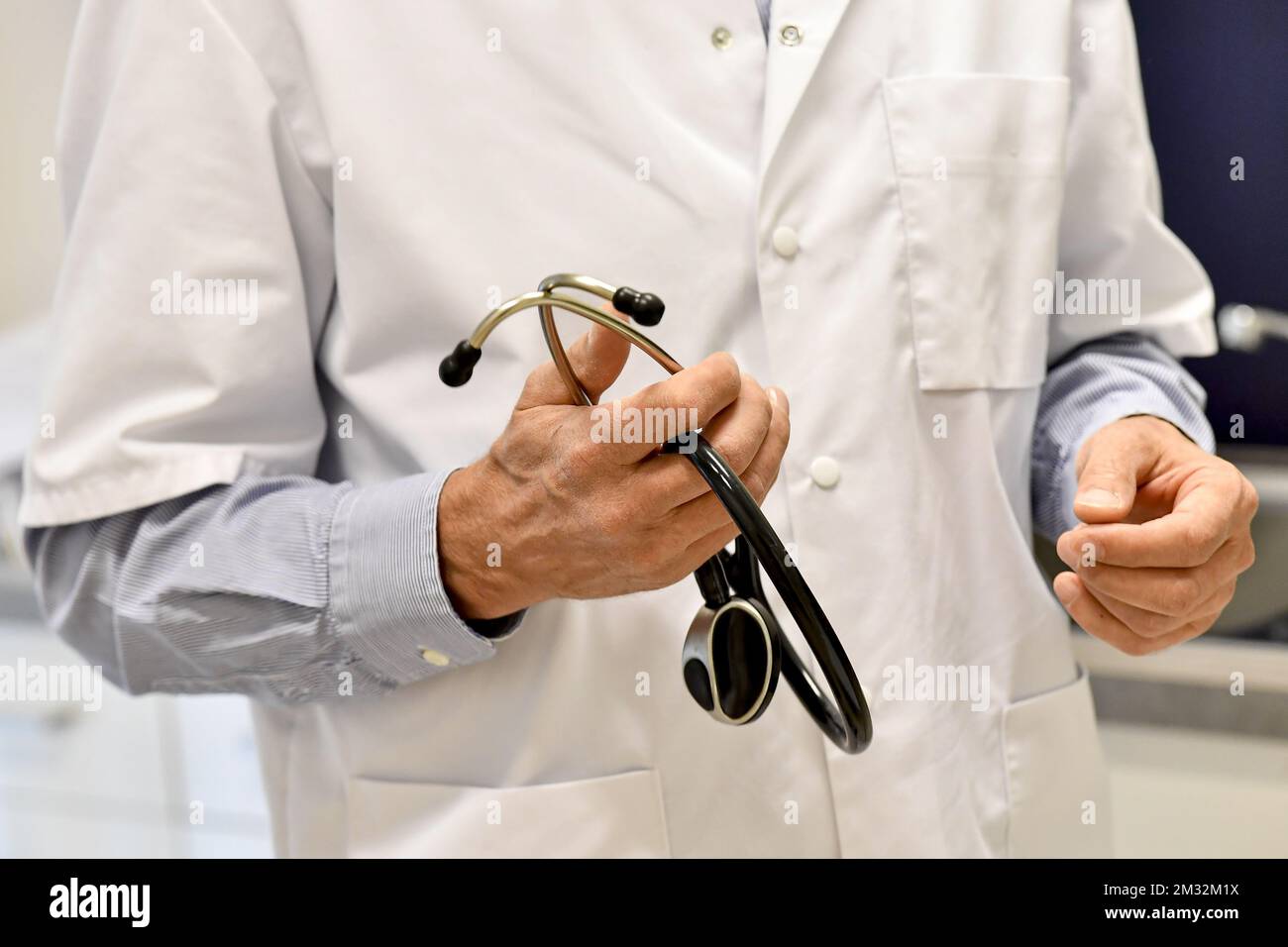 Illustration shows a close up on a doctor holding his stethoscope ...
