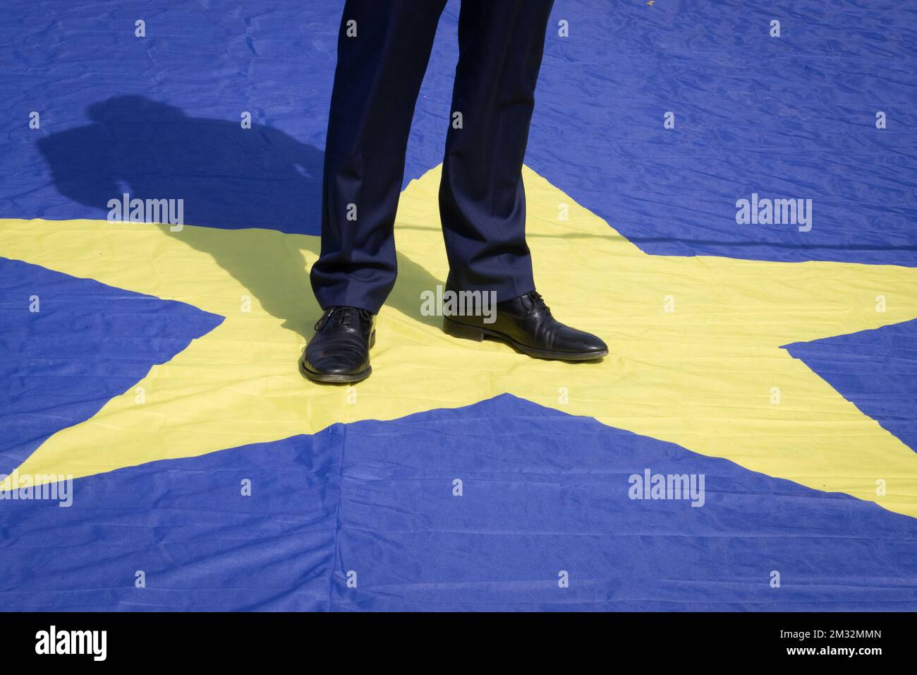 Illustration picture shows a man standing on a european flag during ...