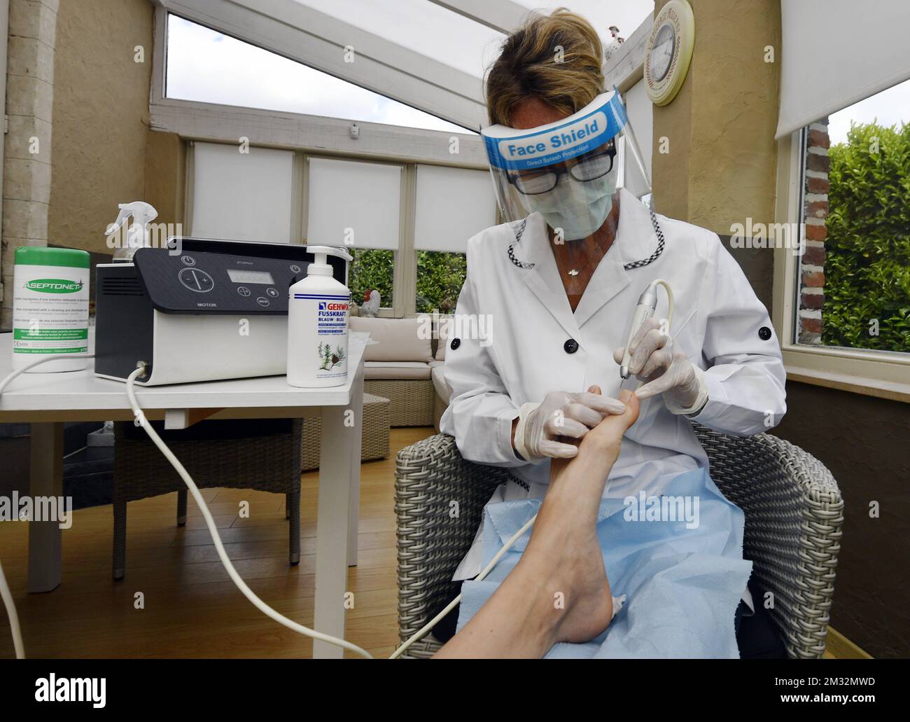 Illustration picture shows a woman pedicure (with protections, mask ...