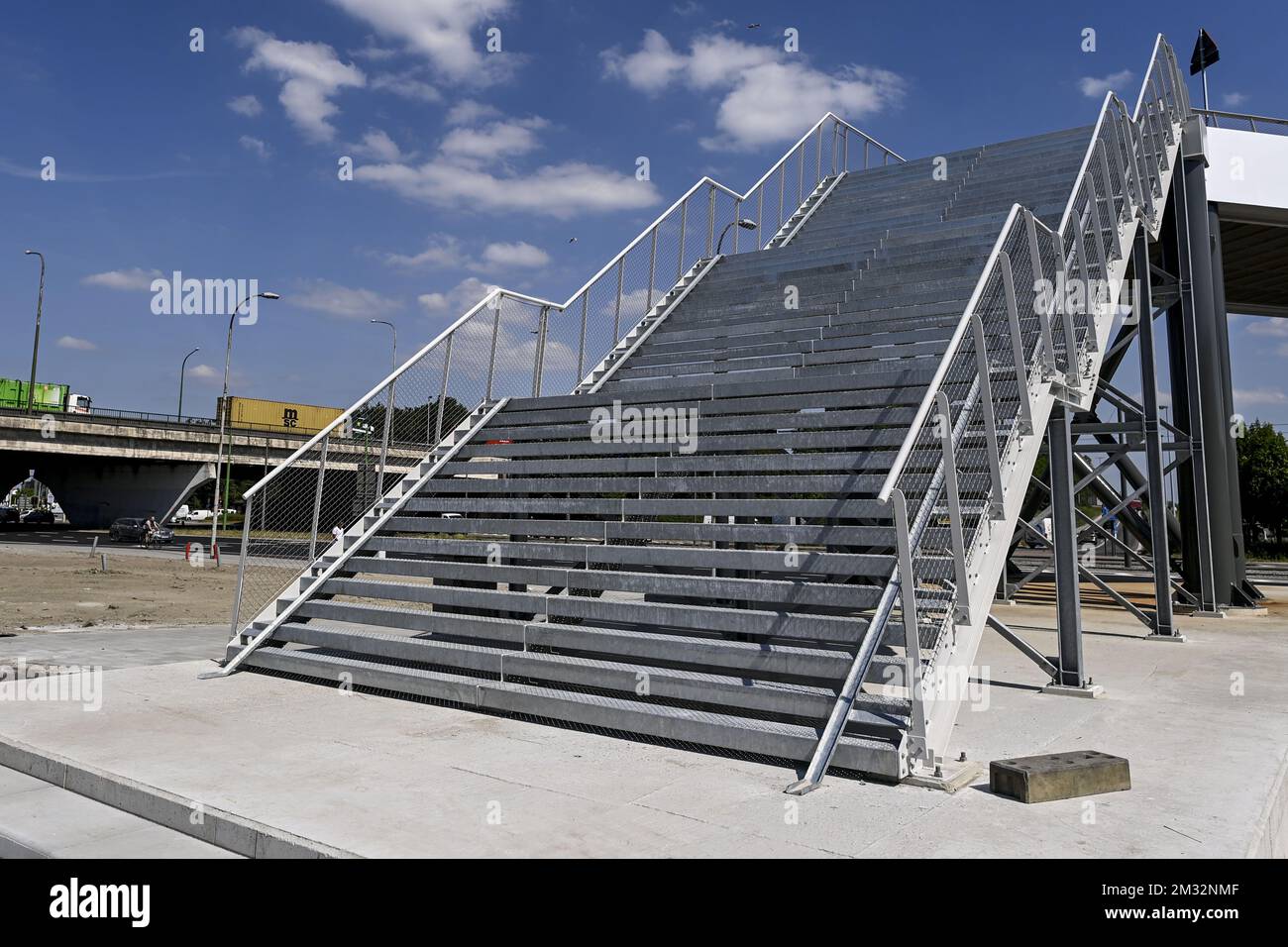 Steps and a bicycle ramp at a pedestrian and cycling bridge over the ...