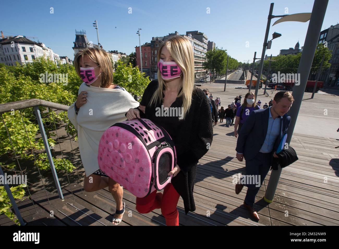 Selena Ali, wearing a mouth mask with the letters 'LEE', and carrying ...