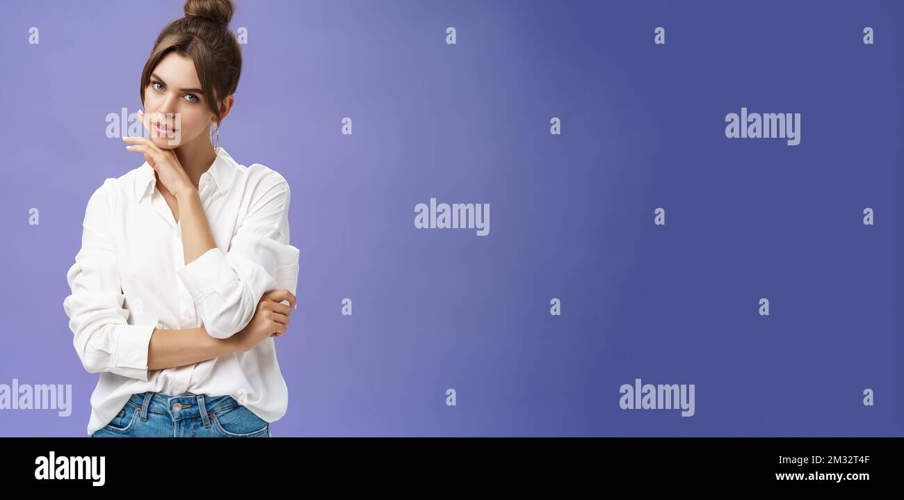 Portrait of tender and feminine stylish woman in white blouse posing ...