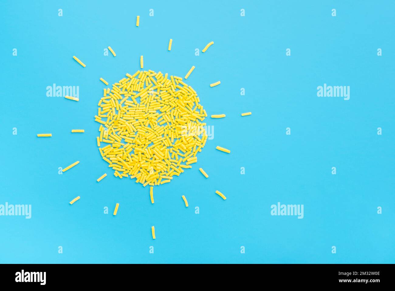 sprinkles on blue background in form of sun, concept of children ...