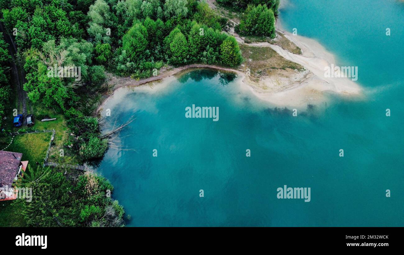 An aerial view of a landscape with lake and trees around Stock Photo ...