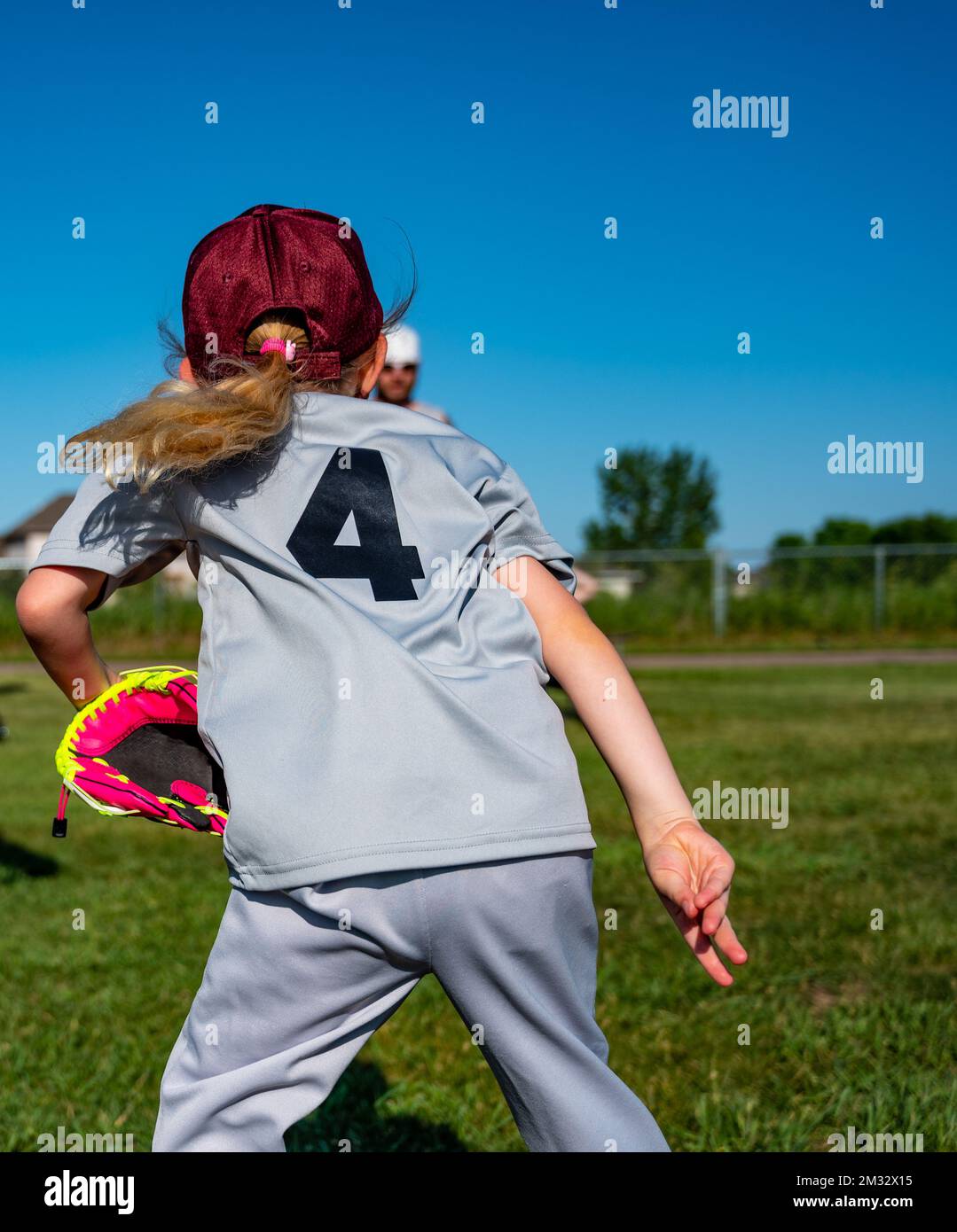 Blonde Caucasian girl with a hat throwing a baseball Stock Photo - Alamy