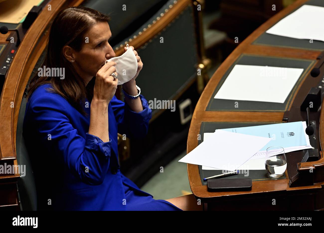Belgian Prime Minister Sophie Wilmes puts on a mouth mask during a ...