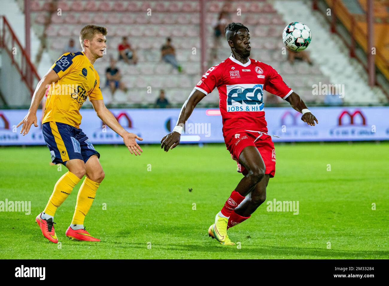 Waasland-Beveren's Jur Schryvers and Kortrijk's Pape Habib Gueye fight for the ball during the ...