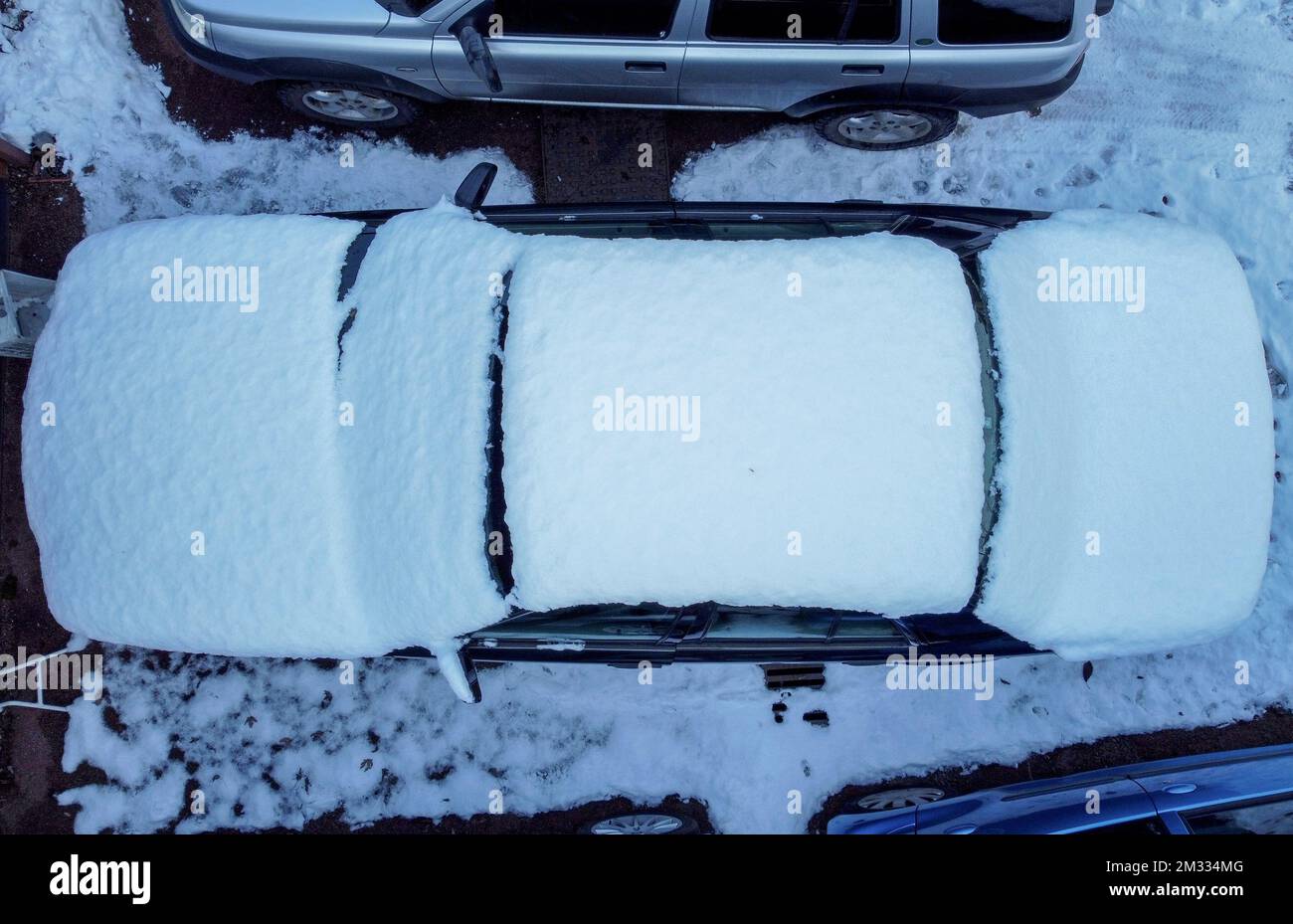 Snow covered car seen from above Stock Photo - Alamy