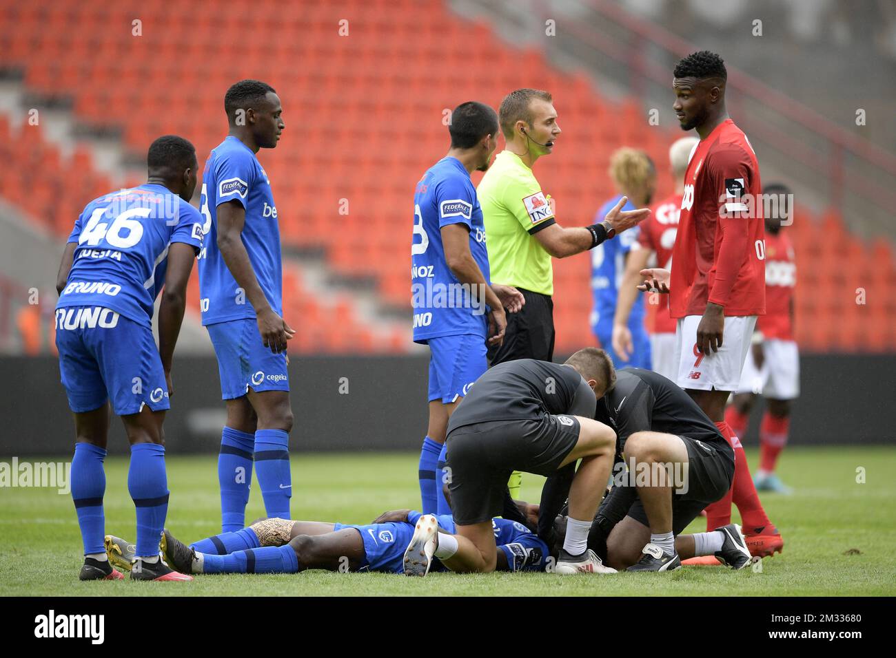 Genk's Eboue Kouassi lies injured on the ground during the Jupiler Pro ...