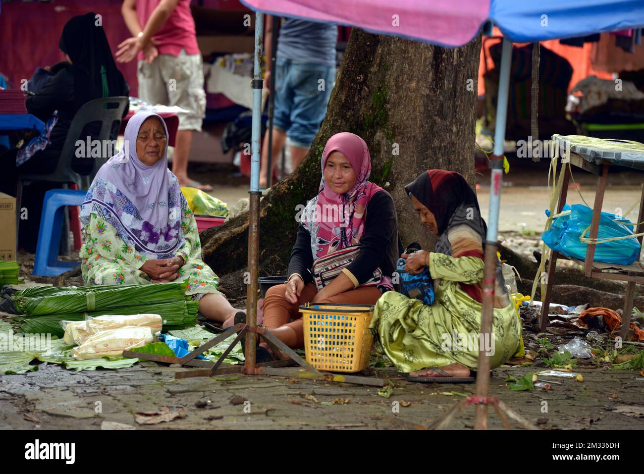 Indigenous Bajau women selling food at the Sunday market (tamu) in Kota ...