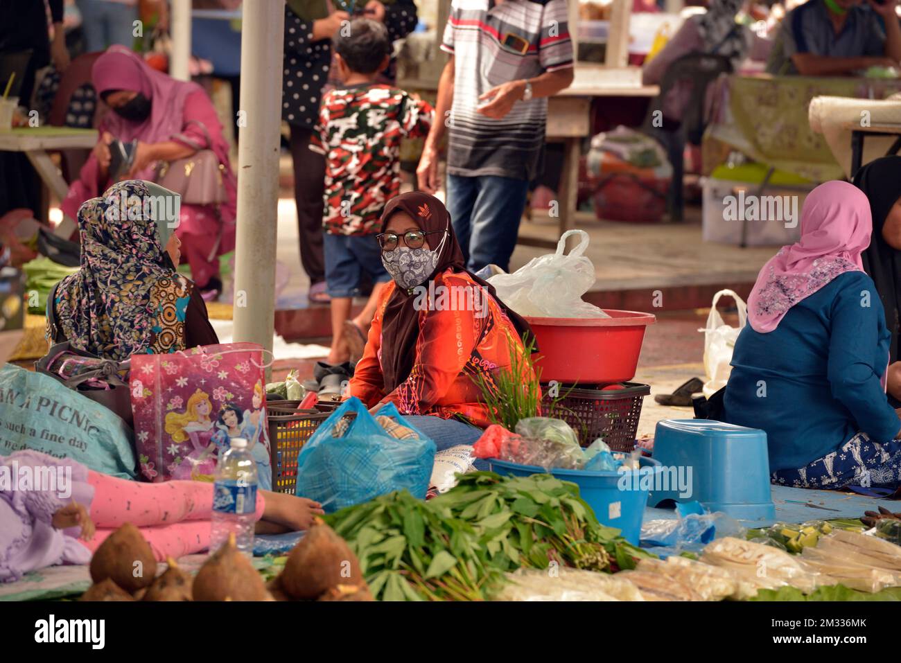 Indigenous Bajau women selling food at the Sunday market (tamu) in Kota ...