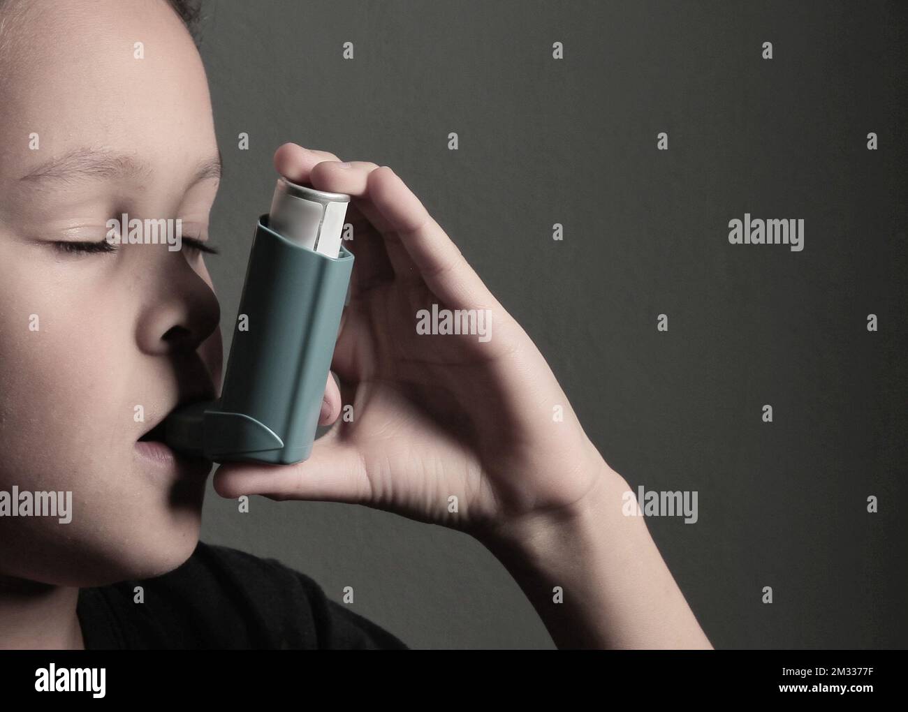 child with flu and inhaler respiratory puff on grey background with ...
