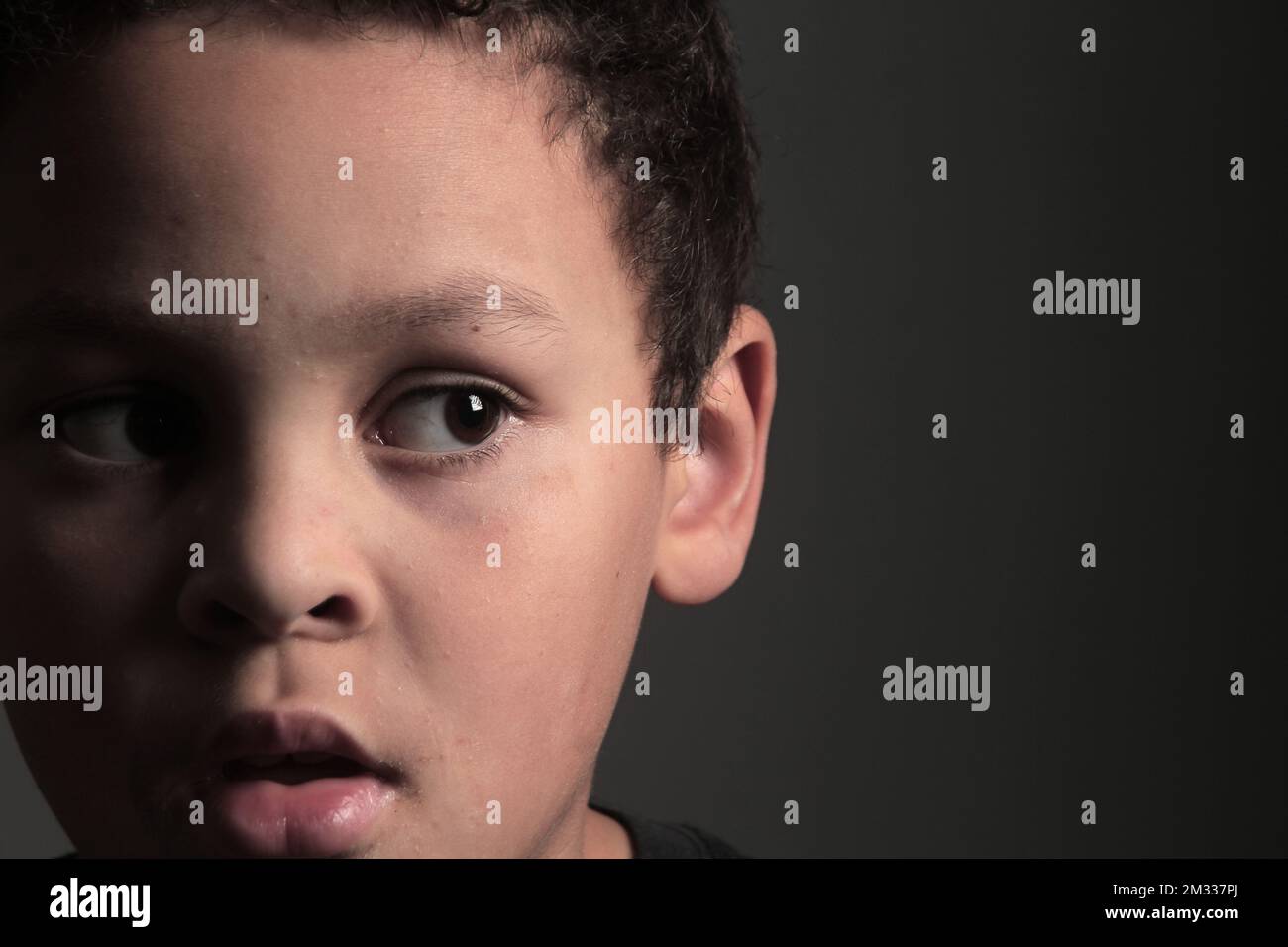 child looking to the side with background with people stock photo Stock ...