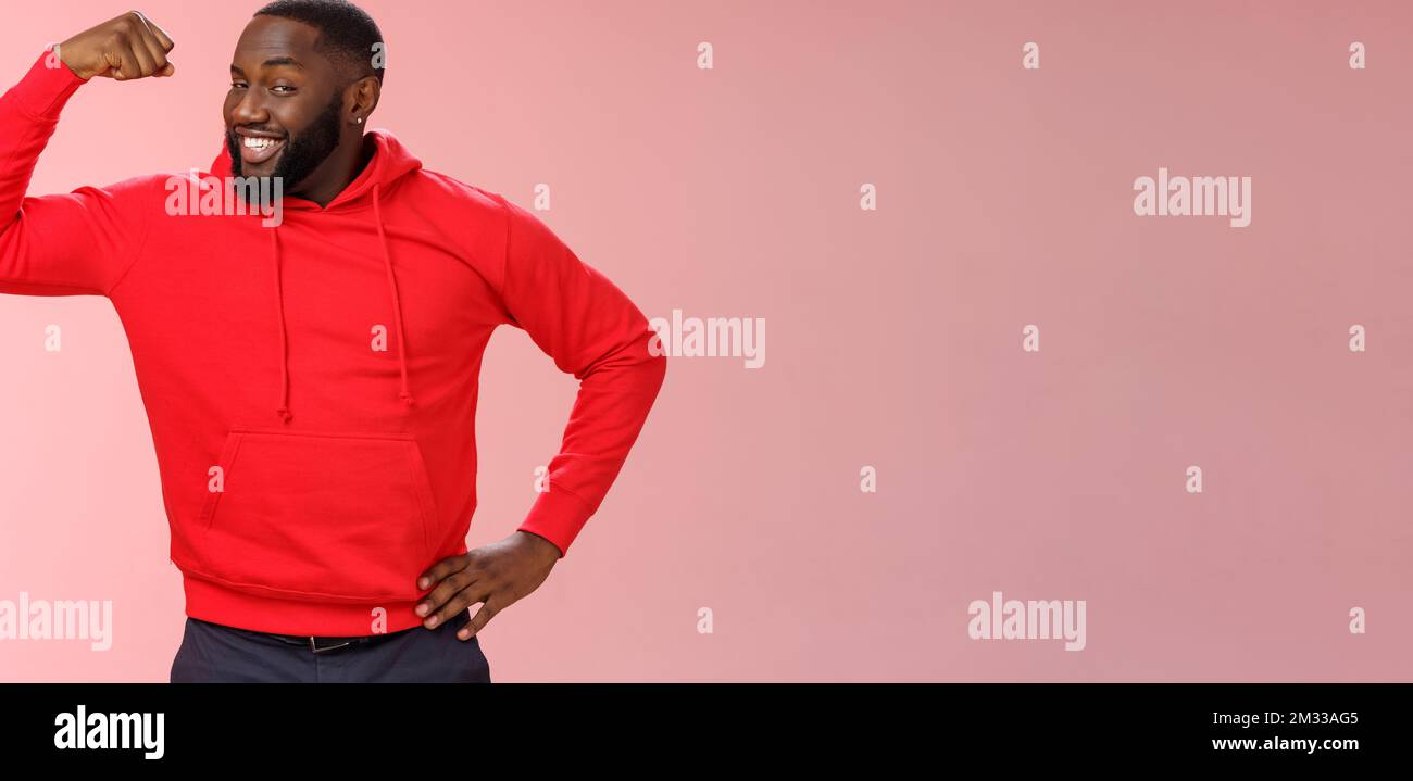 Charming cheeky friendly african-american strong guy smiling broadly ...