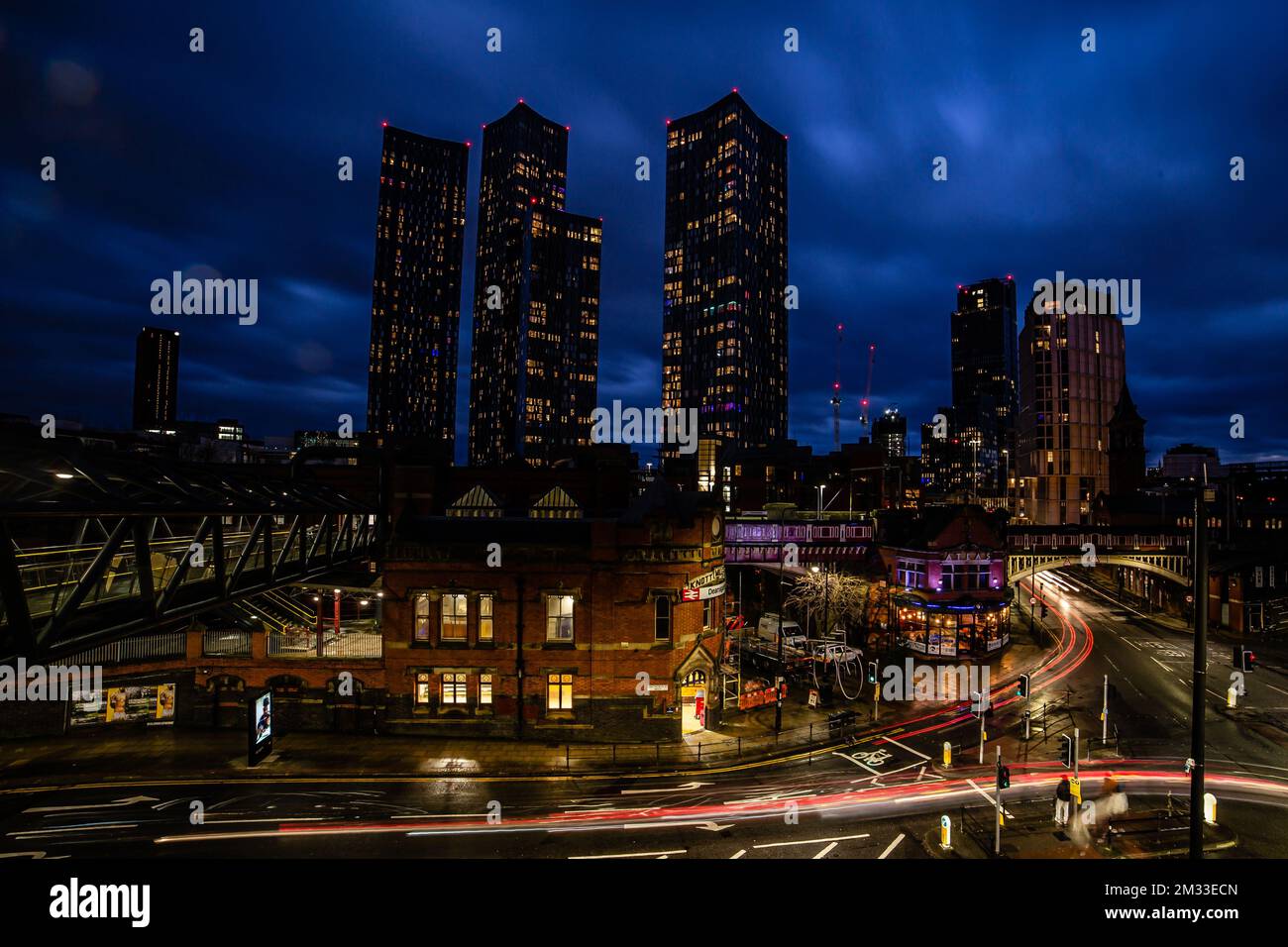 A night view of Deansgate Square with four skyscraper towers under the ...