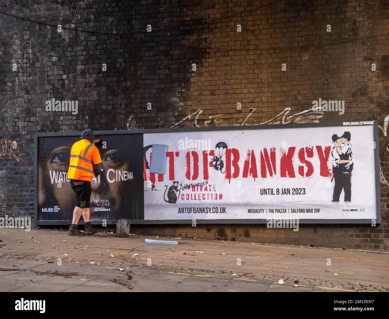 Person pasting posters on the street in England Stock Photo - Alamy