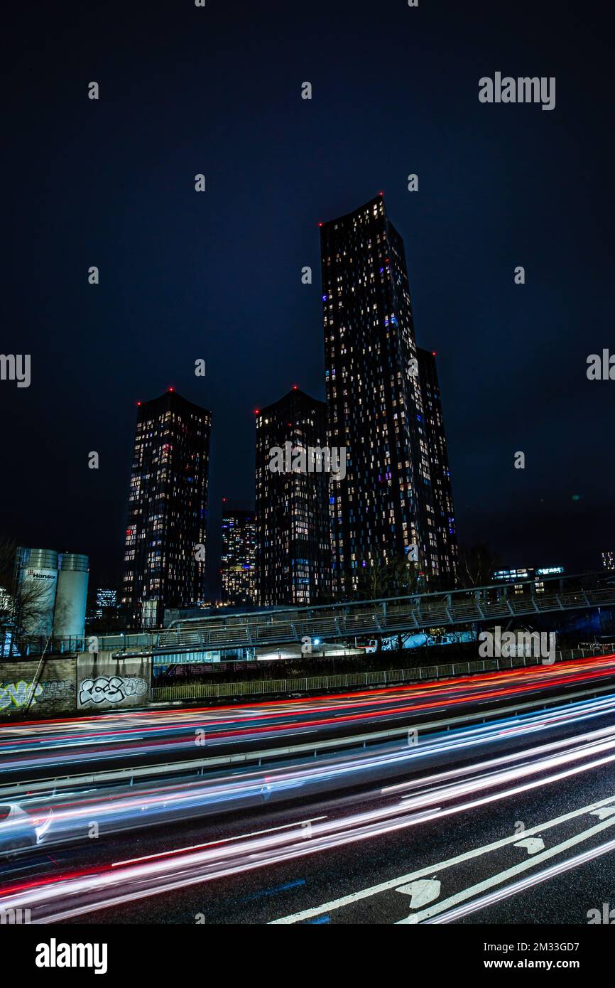 A vertical night view of Deansgate Square with its four towers, and ...
