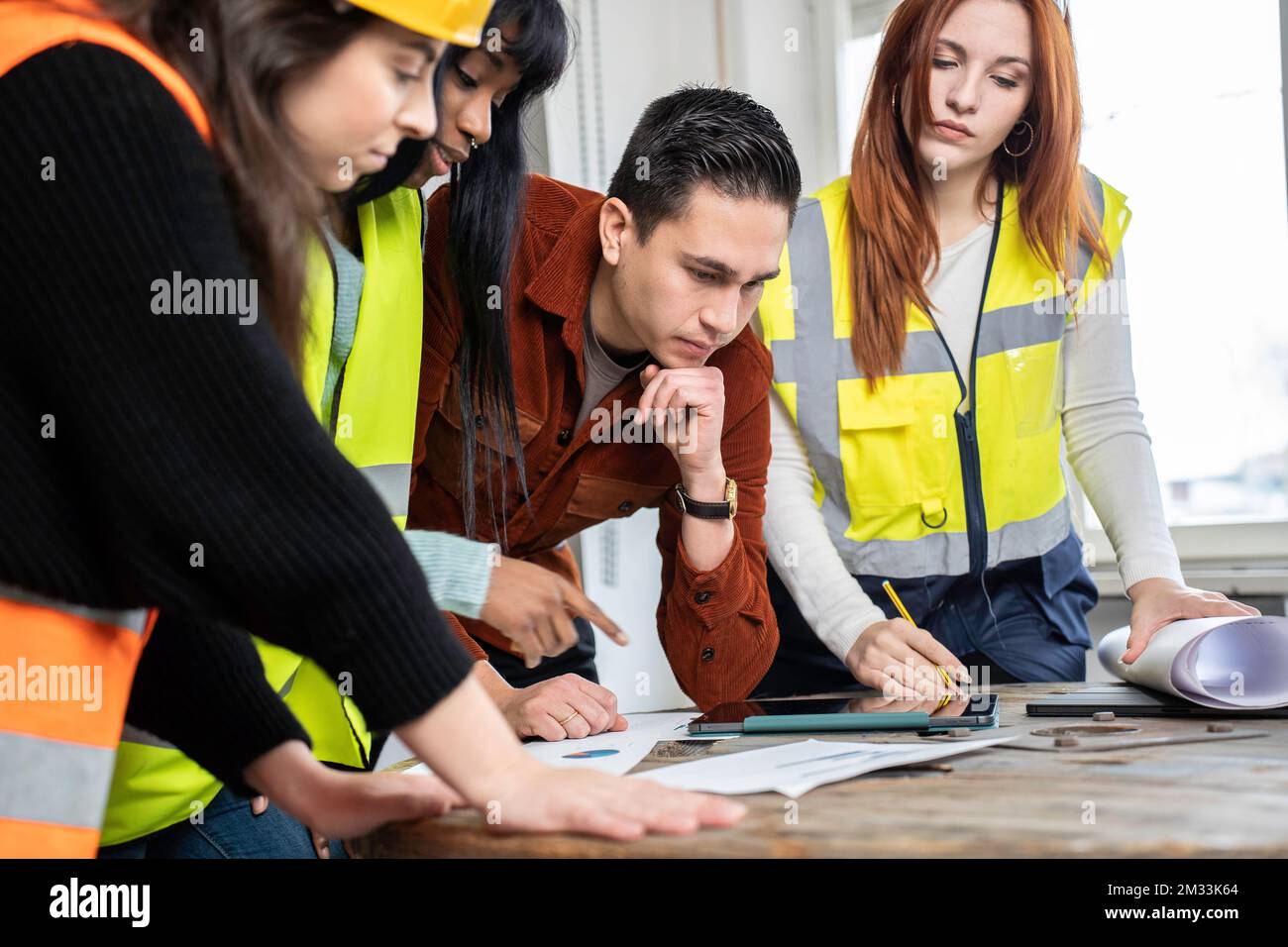 South american engineer supervisor at construction site with his ...