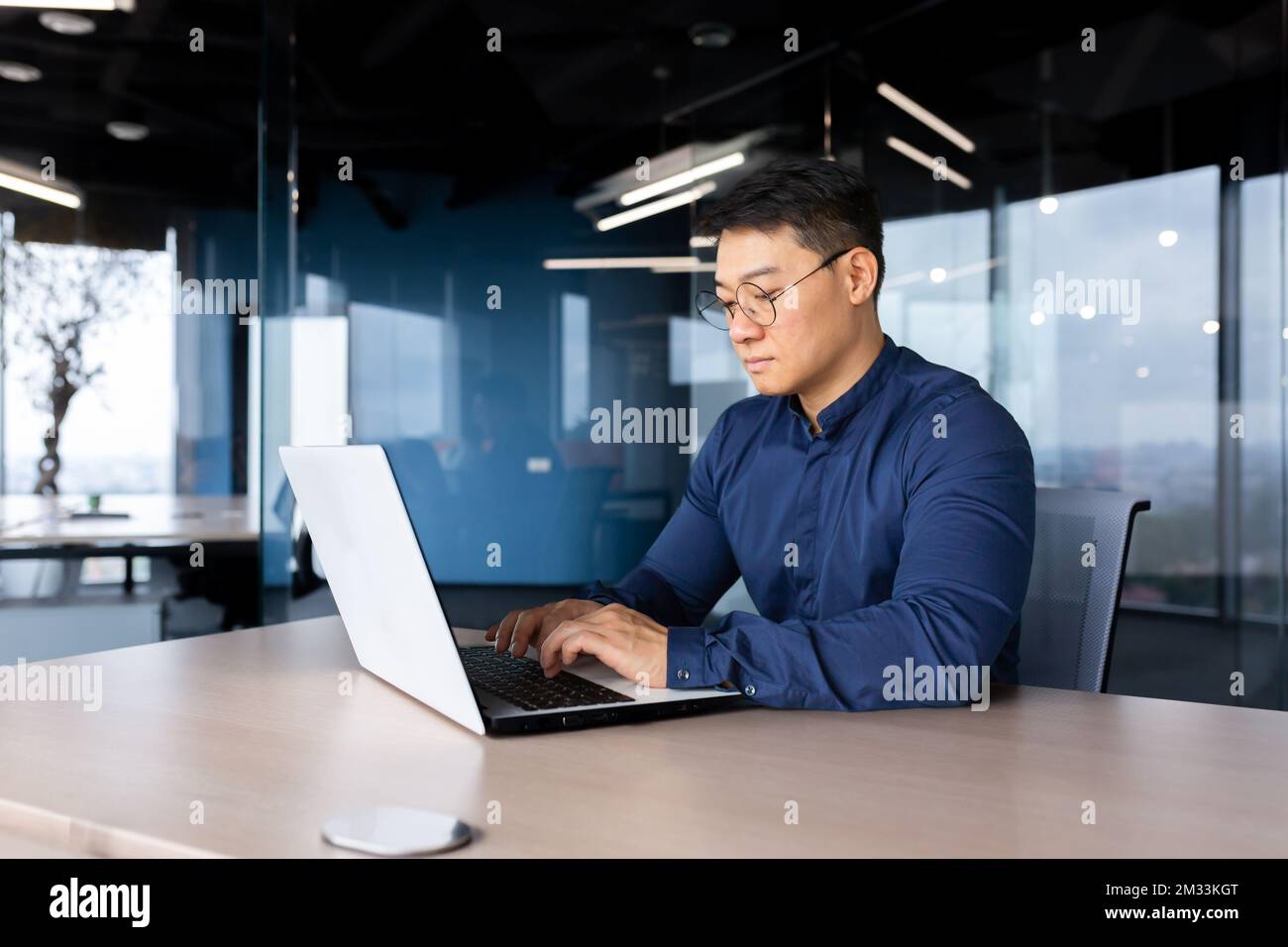 Serious guy using laptop typing hi-res stock photography and images - Alamy