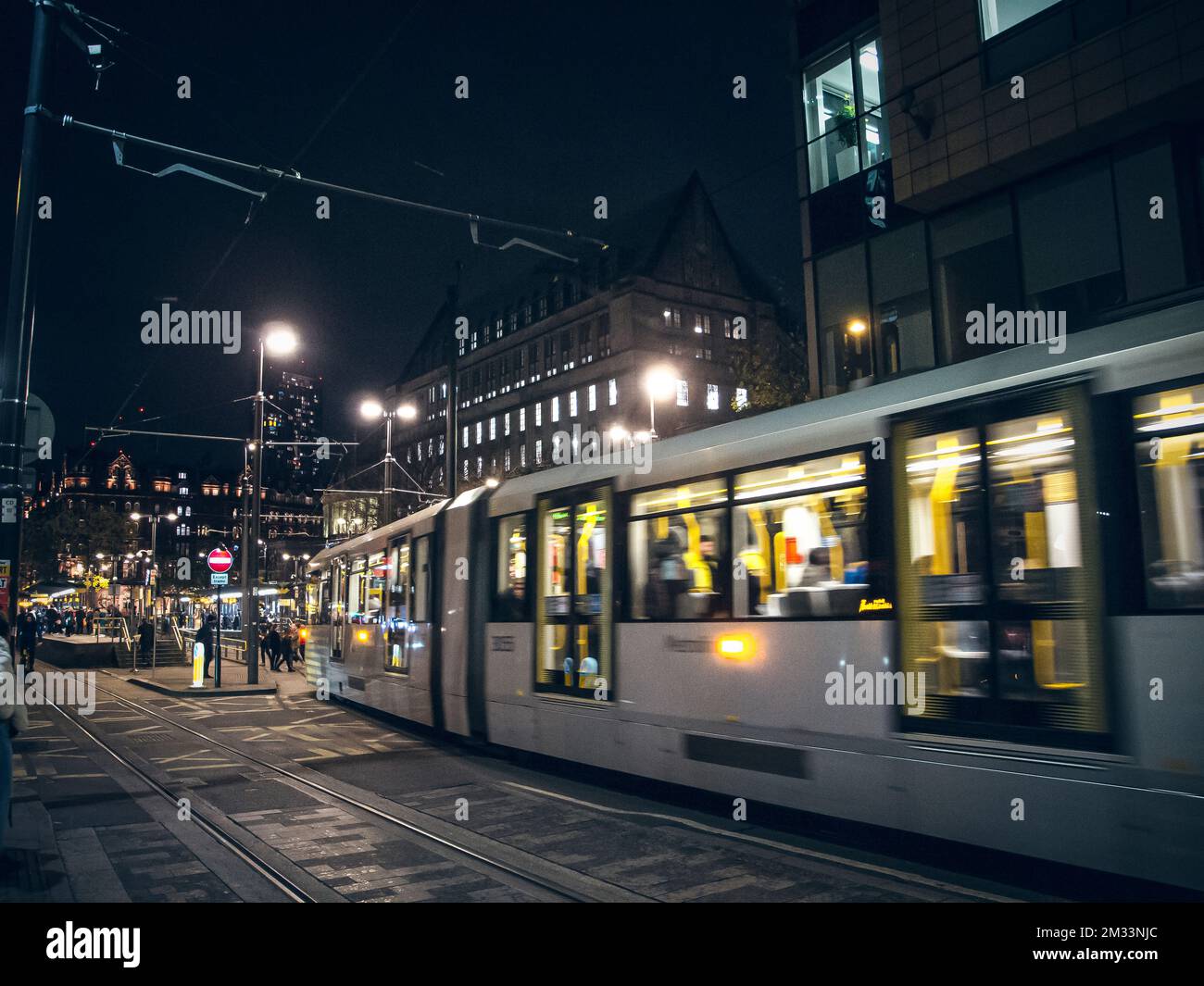 Tram in the city of Manchester at night Stock Photo - Alamy