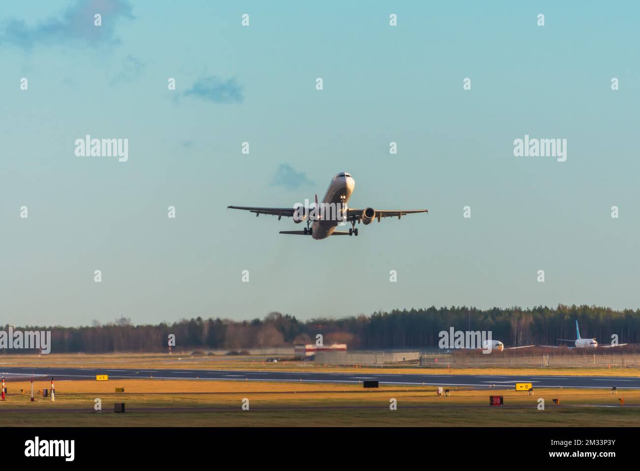 Passenger airplane fly up over take off runway from airport Stock Photo ...