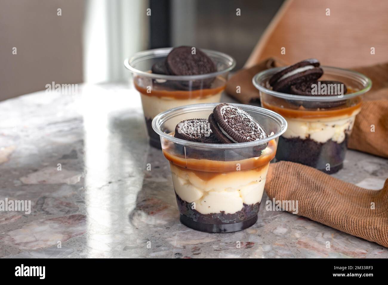 Mini desserts snacks in plastic cups. On the table Cheescake to go ...